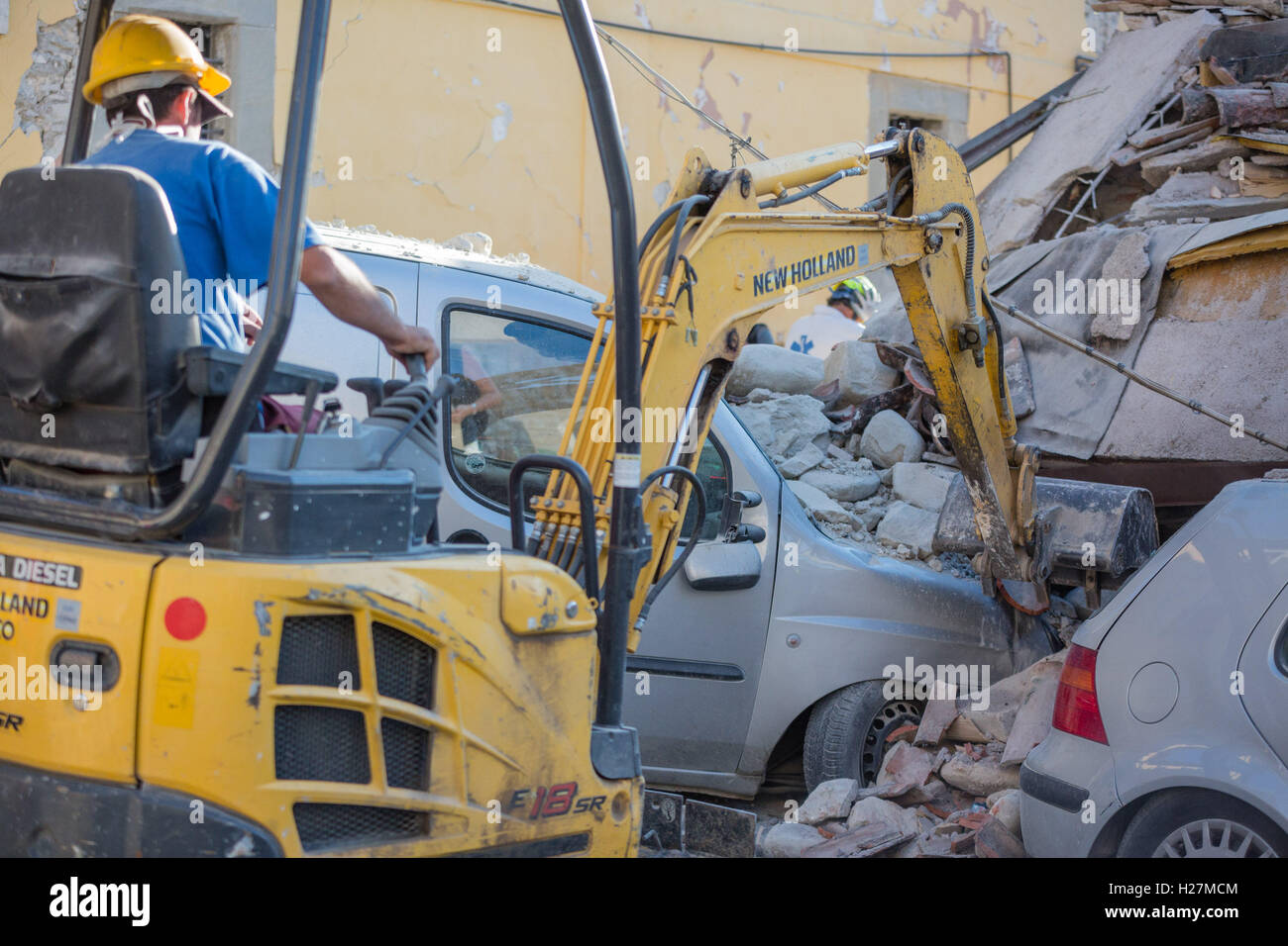 Rescuers clear debris while searching for victims in damaged buildings ...