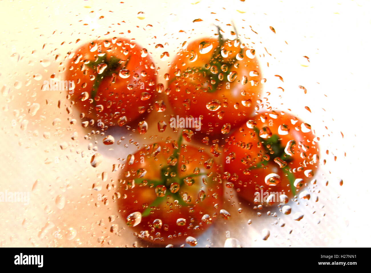 colorful tomatoes through water drops Stock Photo - Alamy