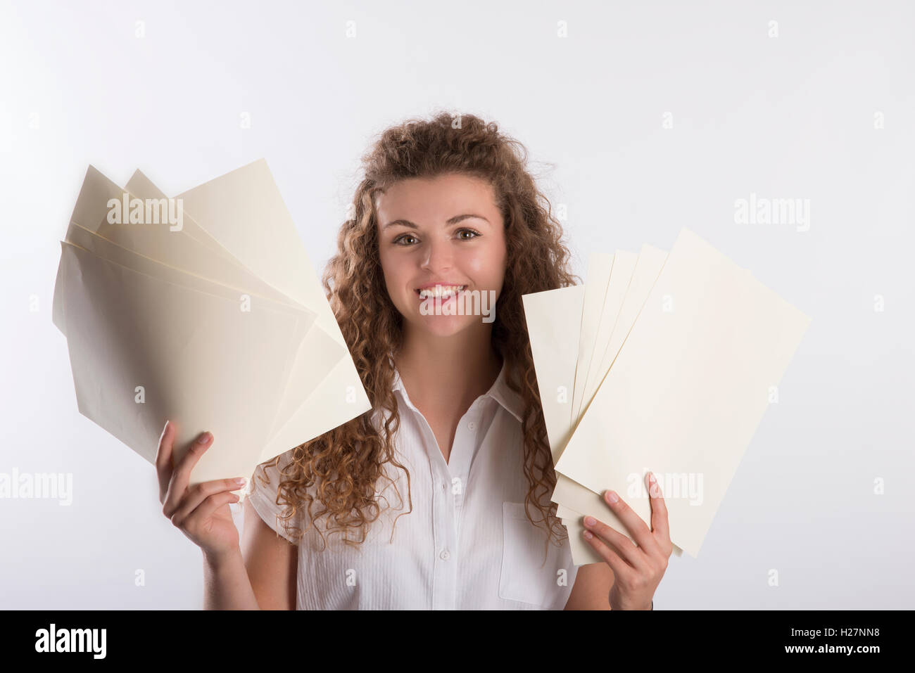 Smiling woman holding paper files Stock Photo - Alamy