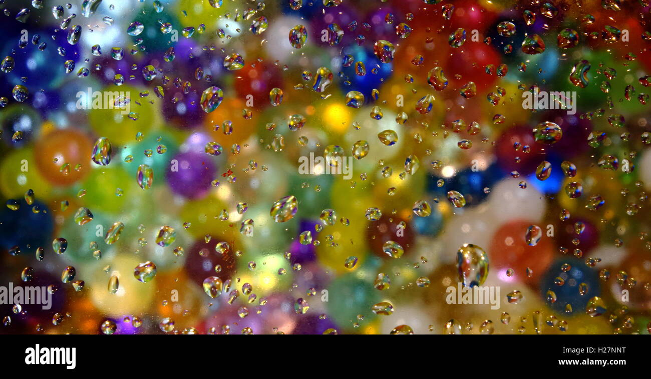colorful object through water drops Stock Photo - Alamy