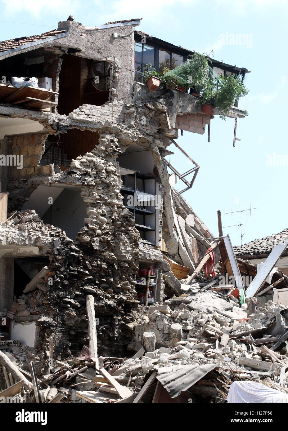 Rescuers clear debris while searching for victims in damaged buildings ...