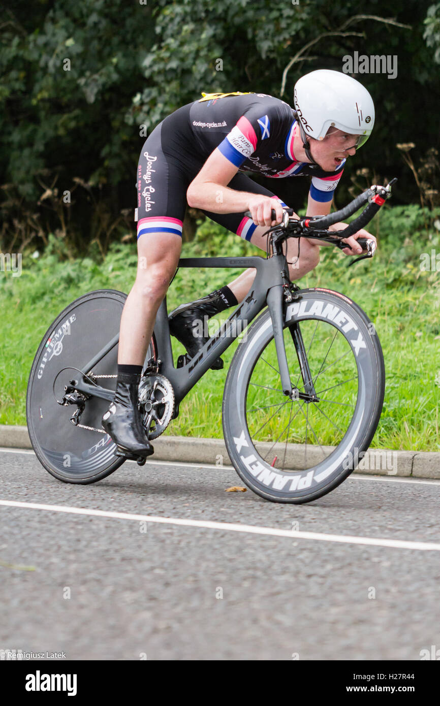 Speeding professionally dressed cyclists on the asphalt during the ...
