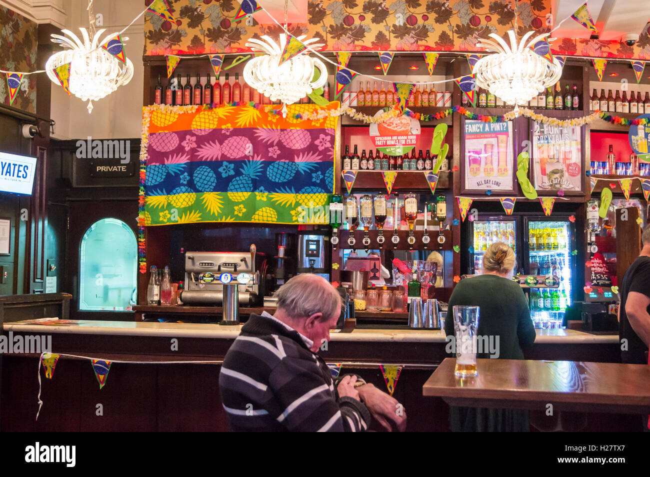 A woman ordering drinks at the bar of Yates's Wine Lodge, Portland ...
