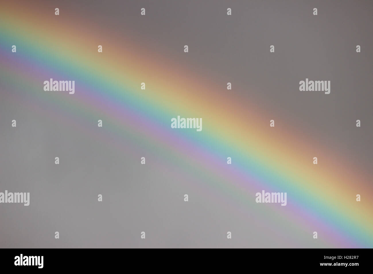 bright colorful wide colorful rainbow after the storm in the gray sky ...