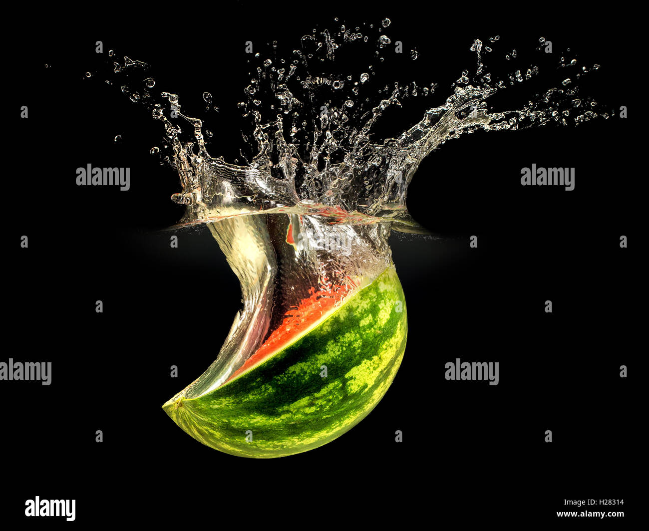 Fresh melon falling in water with splash on black Stock Photo - Alamy