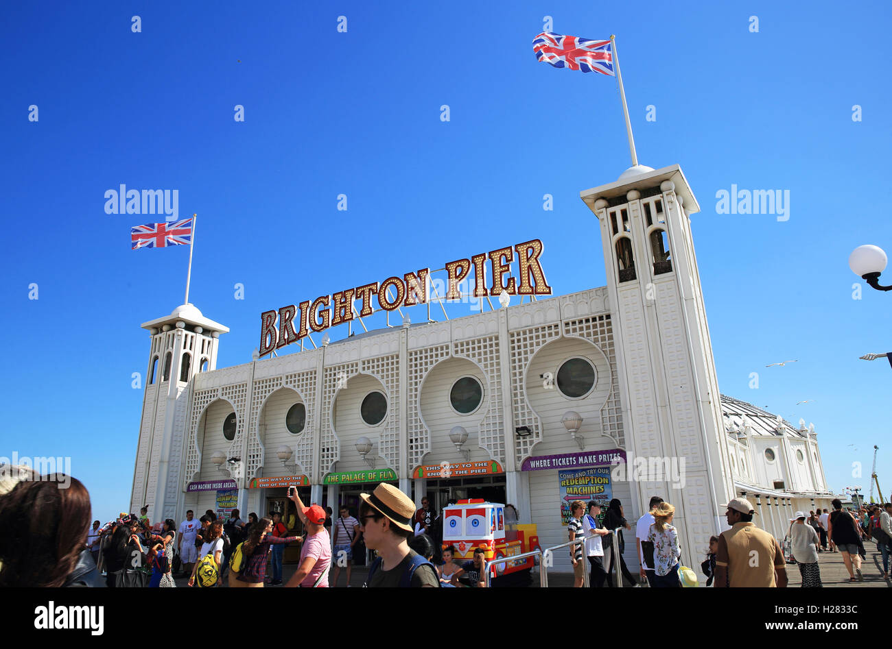 The entrance to the iconic Palace Pier, in Brighton, on a warm, summer ...