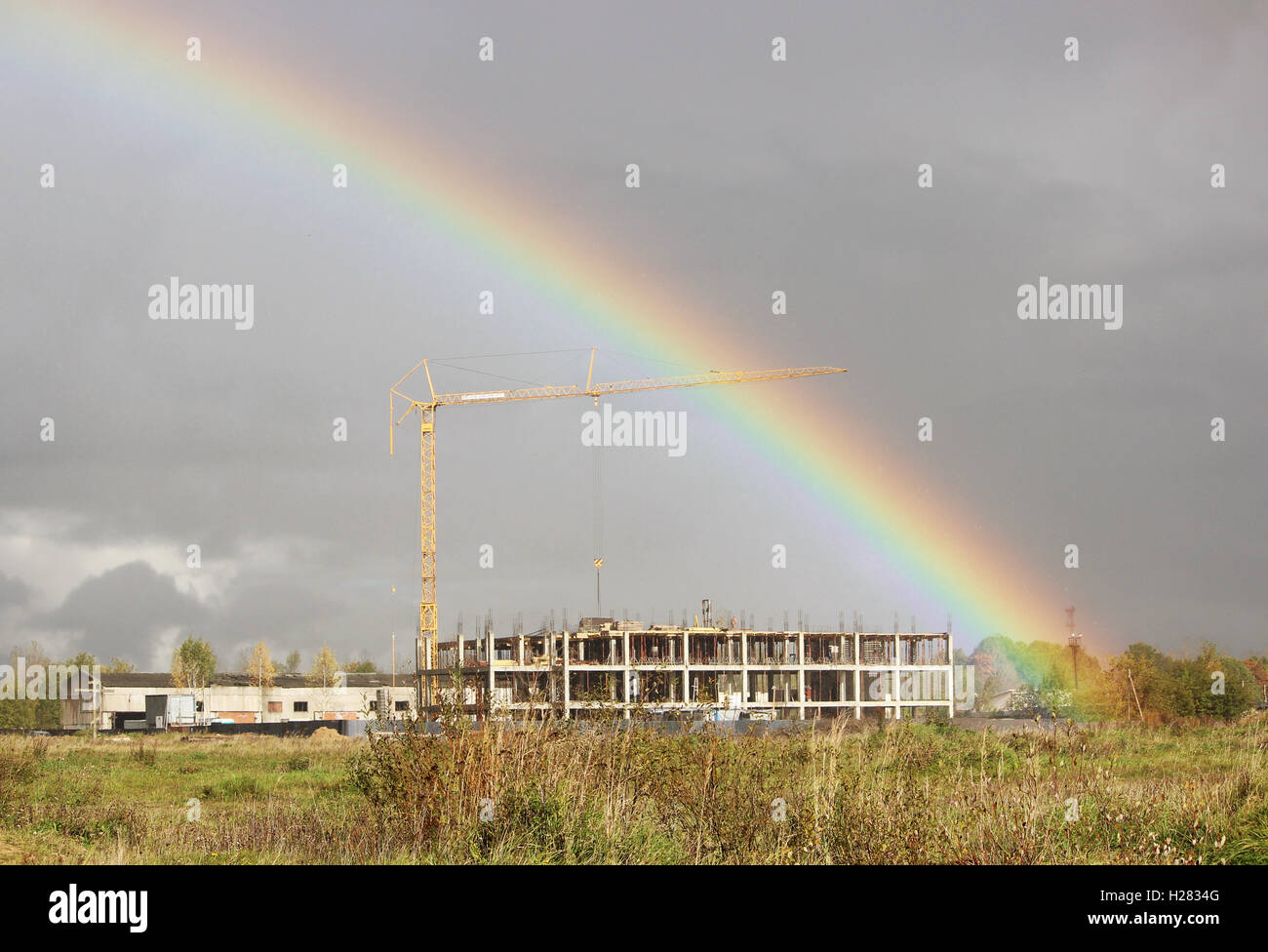 bright colorful wide colorful rainbow and a crane on a construction ...