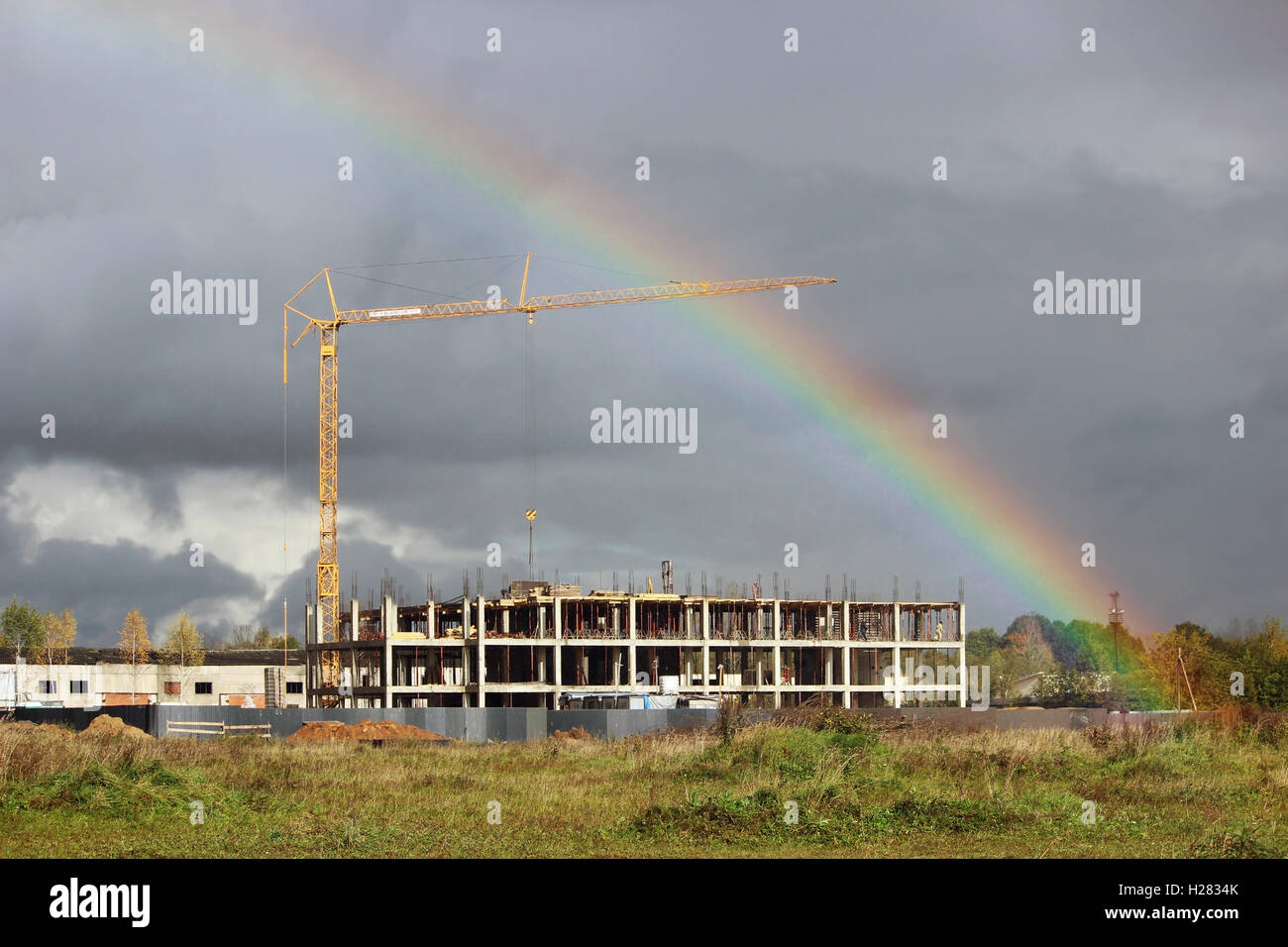 bright colorful wide colorful rainbow and a crane on a construction ...