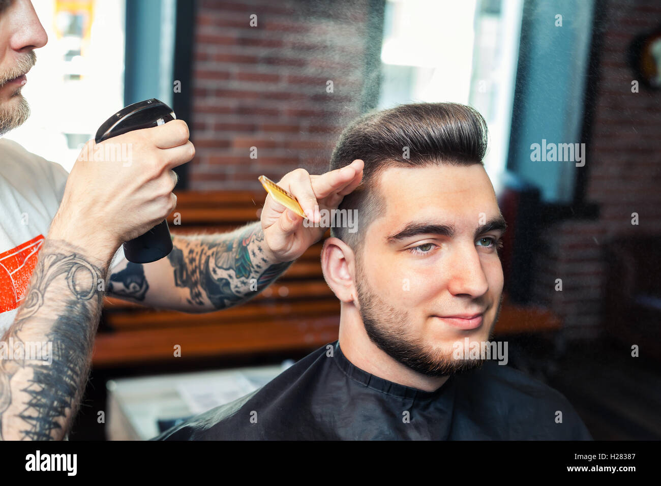 Young man having hair cutted Stock Photo - Alamy