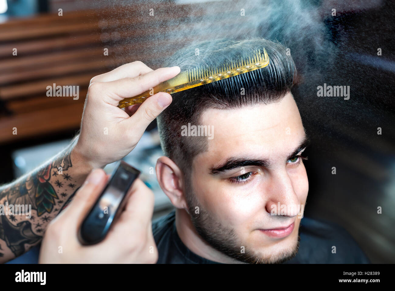 Young man having hair cutted Stock Photo - Alamy