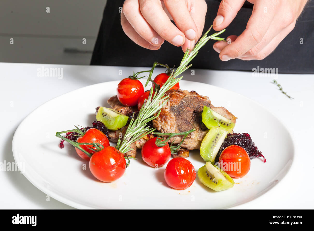 Chef decorating meat dish Stock Photo - Alamy