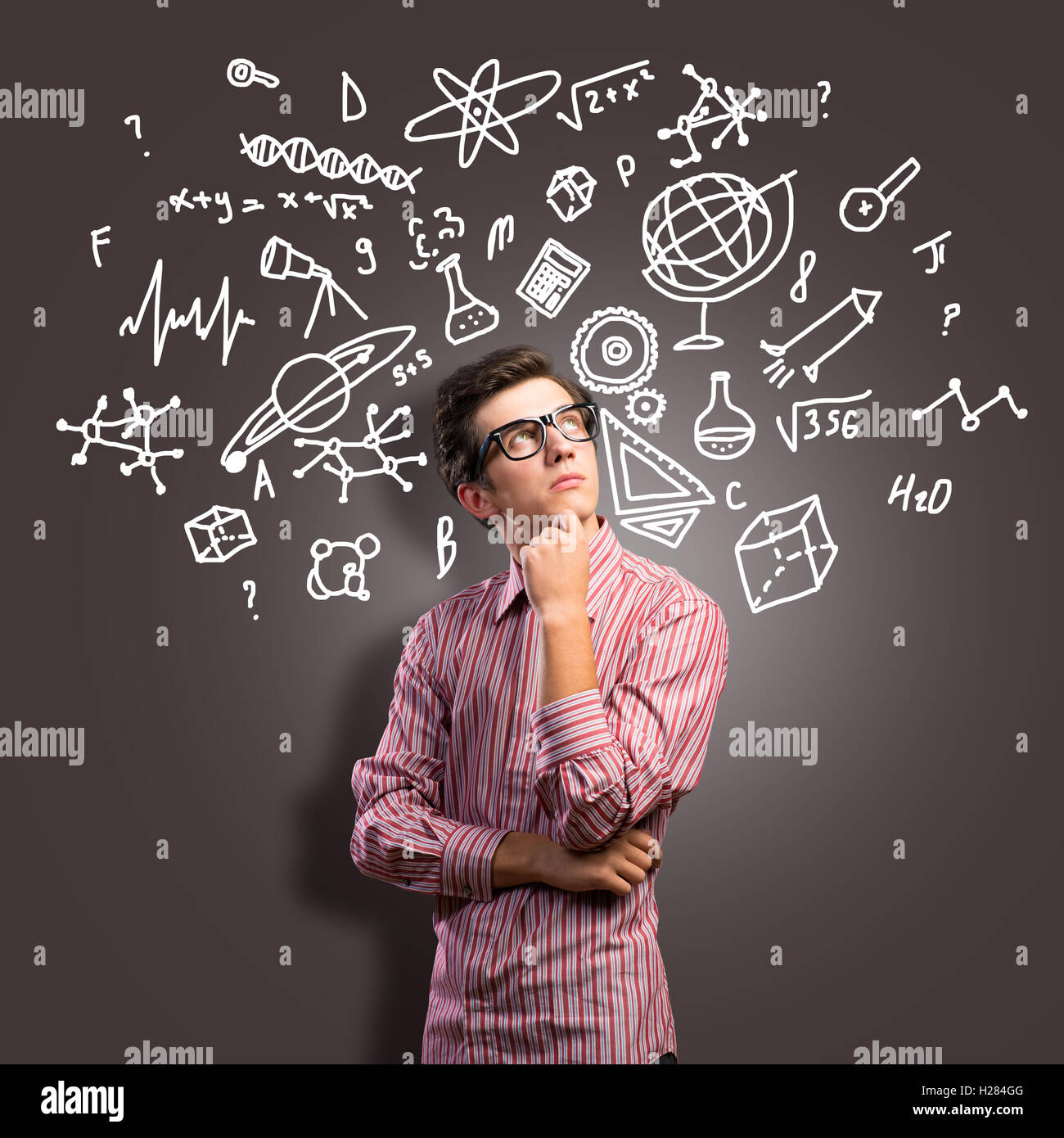 young man scientist with glasses thinking Stock Photo - Alamy