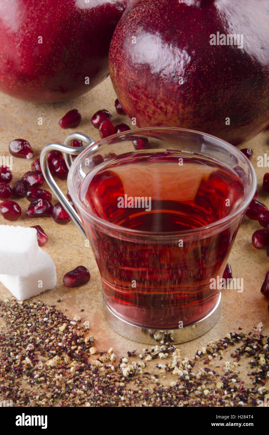 pomegranate seed tea with sugar in a glass Stock Photo - Alamy