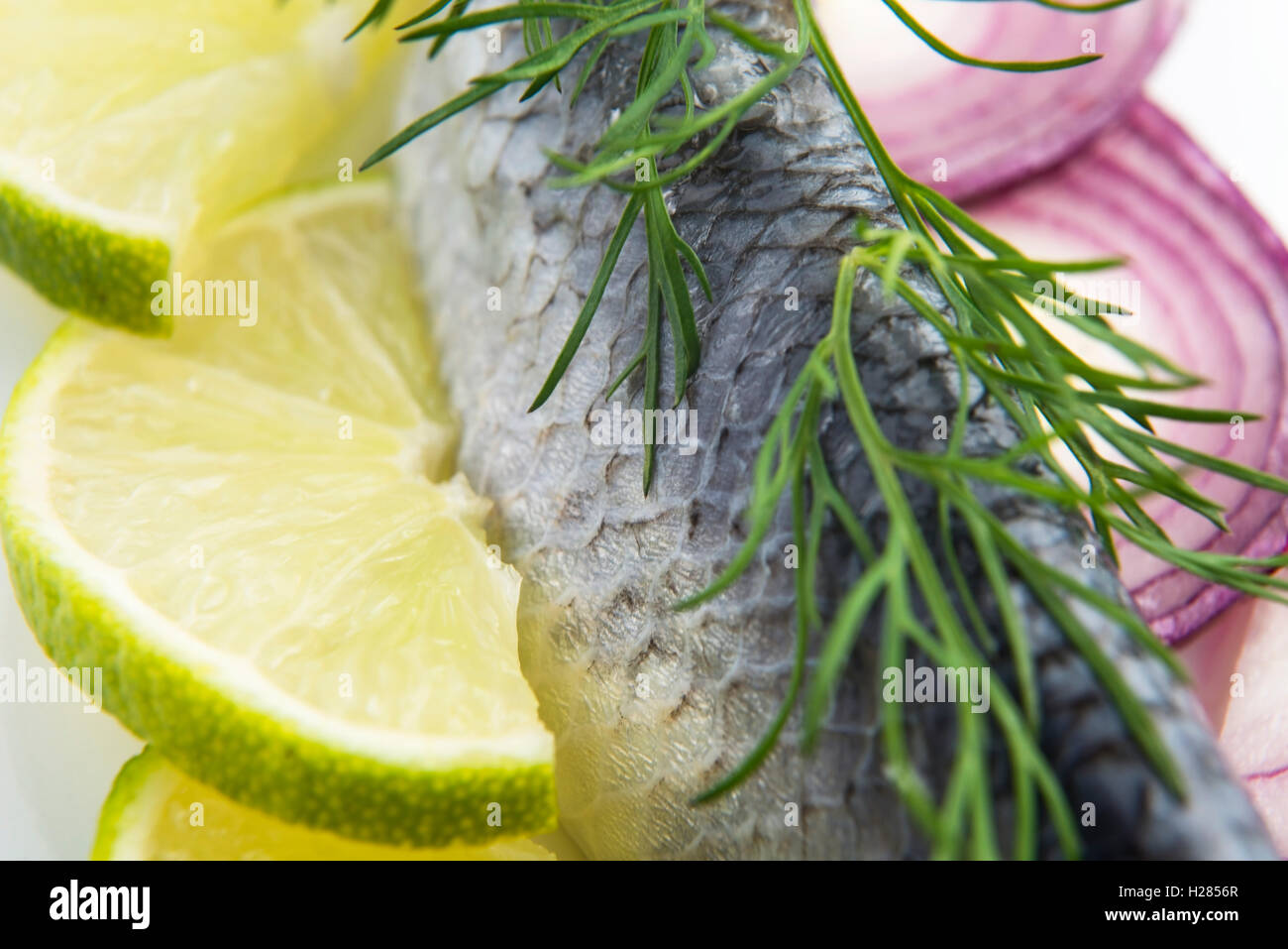 Fillet herring with onion and lemon Stock Photo - Alamy