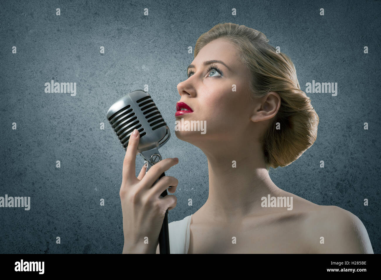 attractive female singer with microphone Stock Photo - Alamy