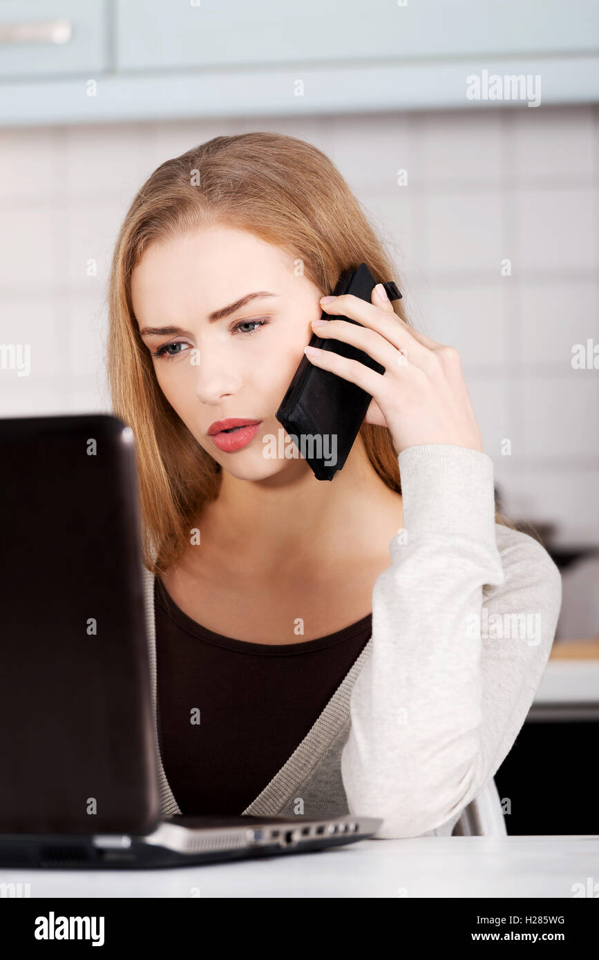 Beautiful caucasian woman talking through phone and working with Stock ...