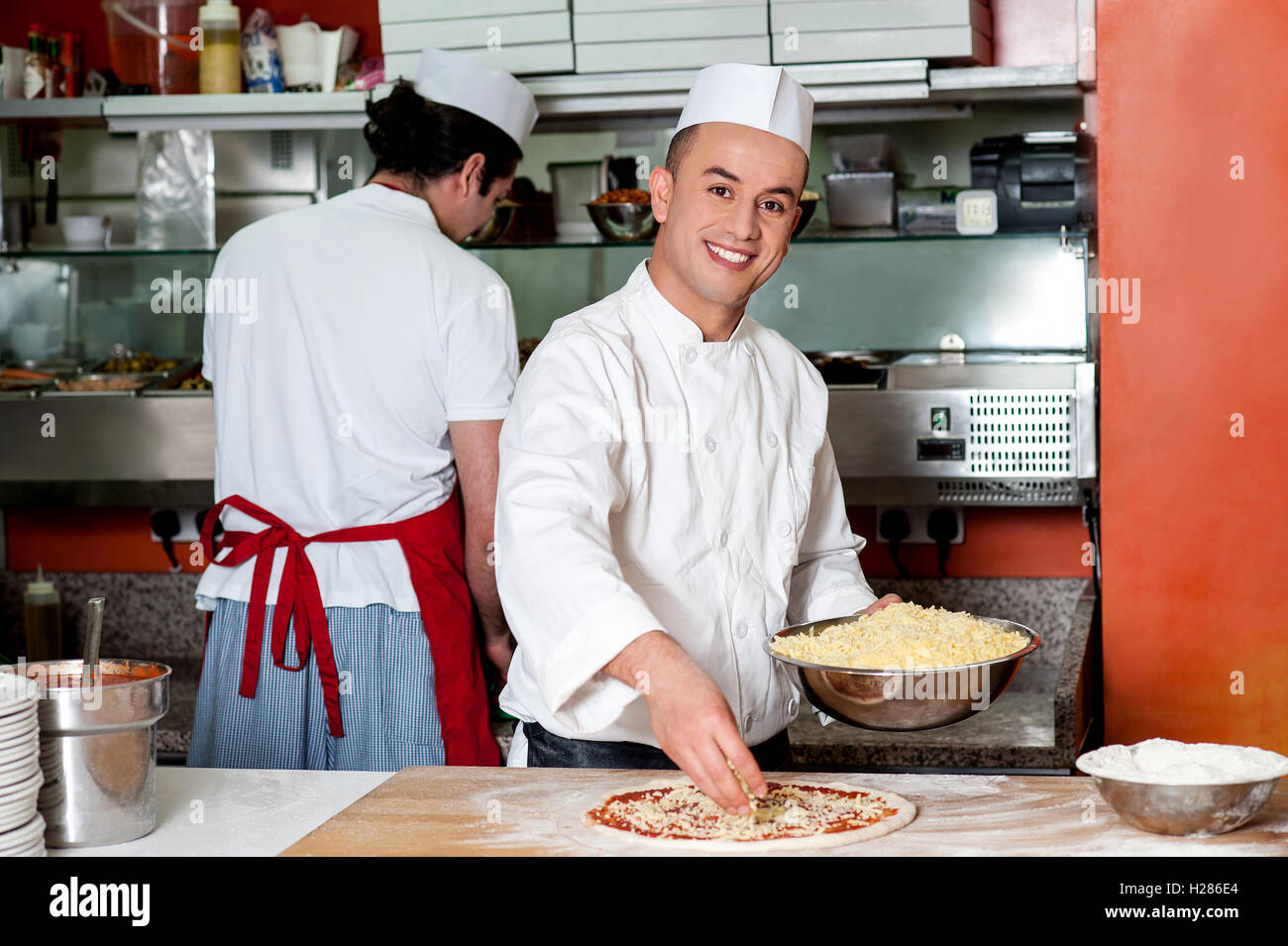 Chefs at work inside restaurant kitchen Stock Photo - Alamy