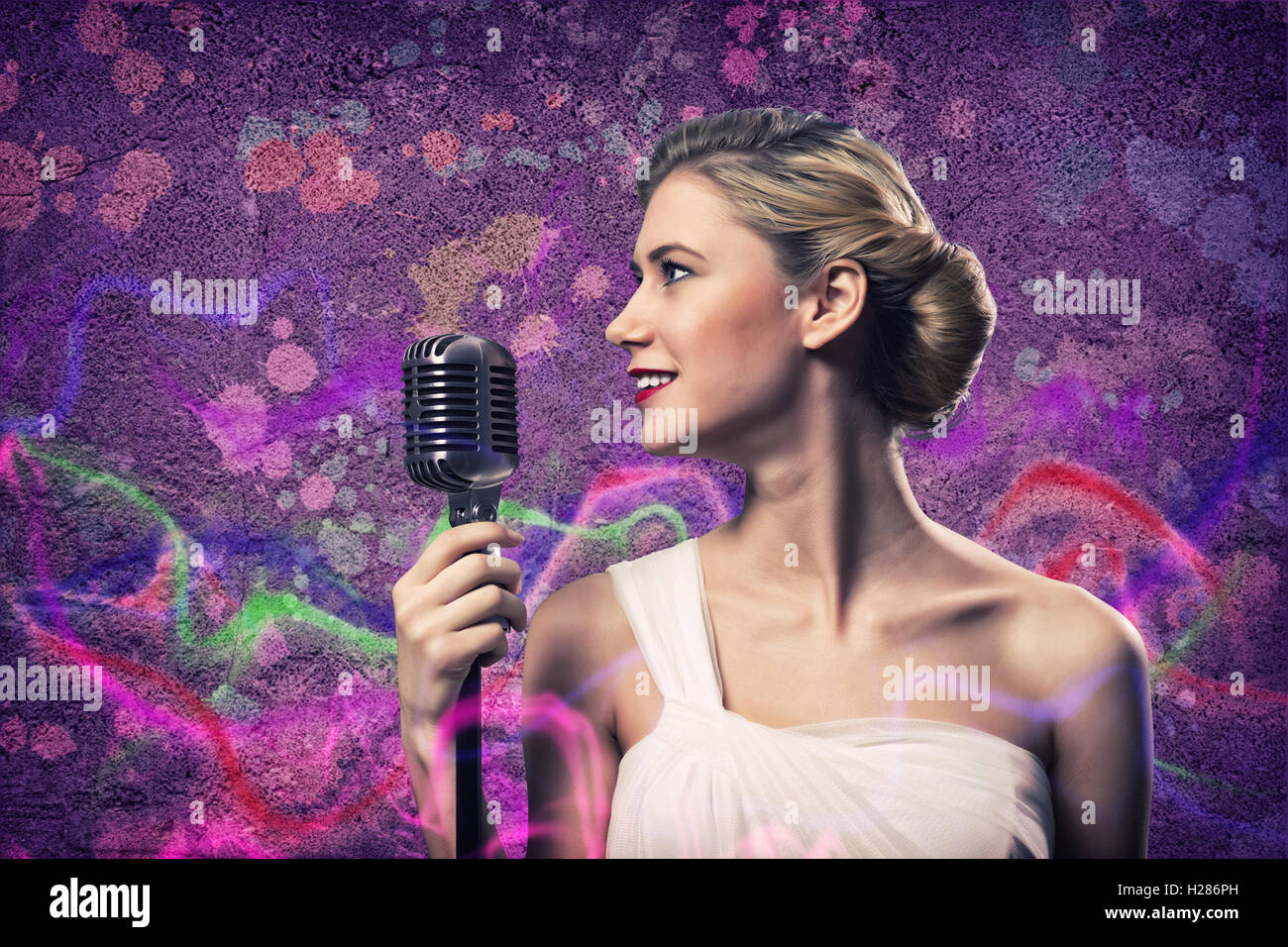 attractive female singer with microphone Stock Photo - Alamy