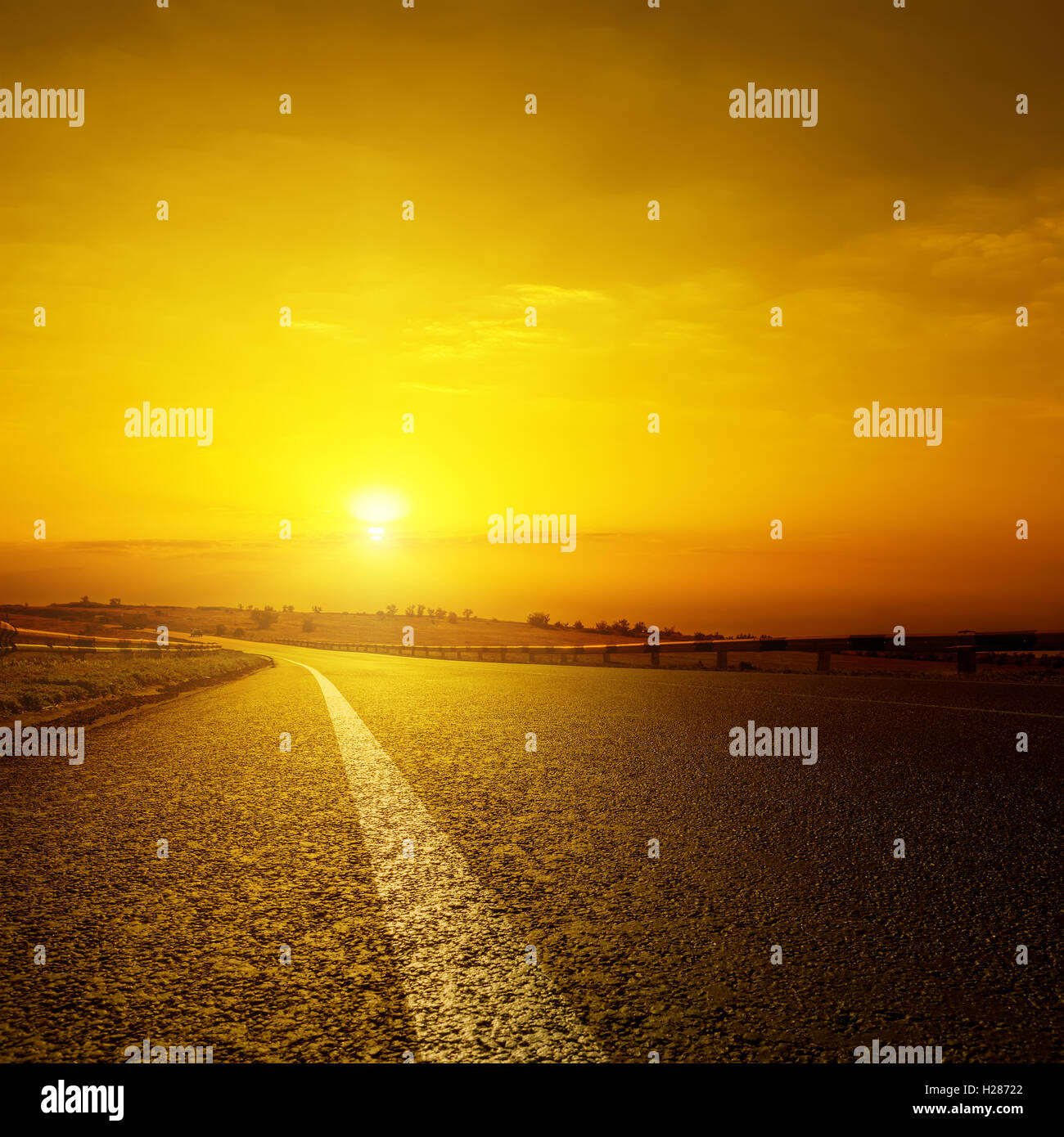 asphalt road and orange sunset Stock Photo - Alamy