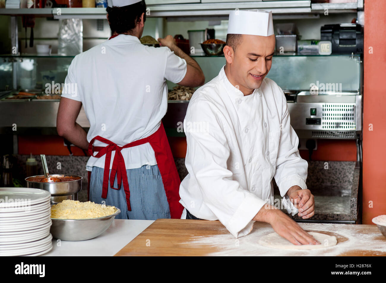 Chef preparing pizza base Stock Photo - Alamy