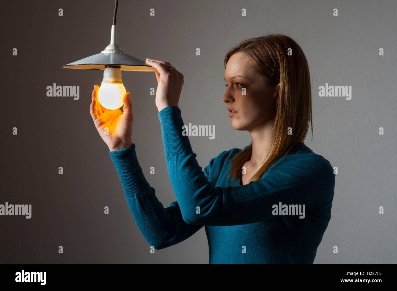 woman with a light bulb Stock Photo - Alamy