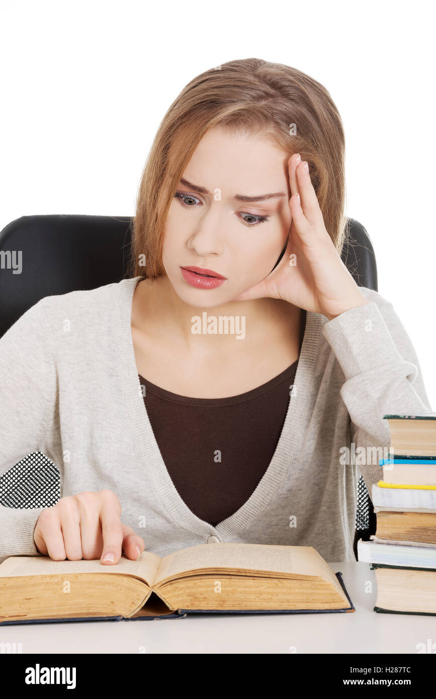 Beautiful casual woman student worried, scared is sitting by a d Stock ...