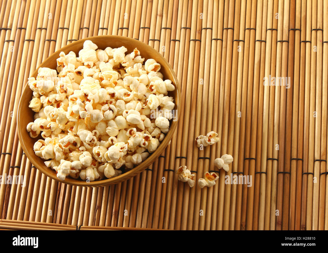 popcorn in bowl over mat background Stock Photo - Alamy