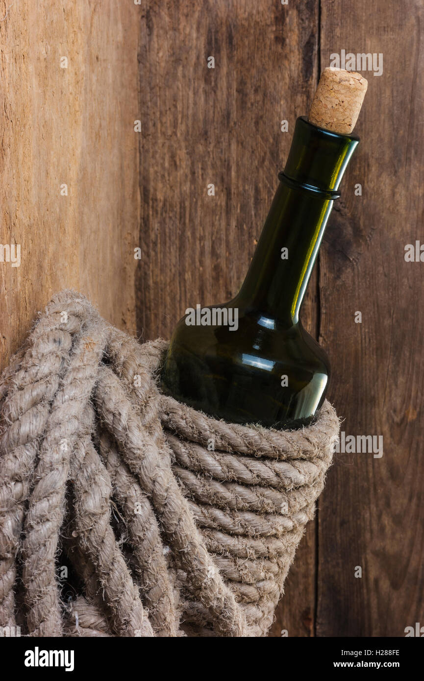 bottle of wine wrapped with rope Stock Photo - Alamy