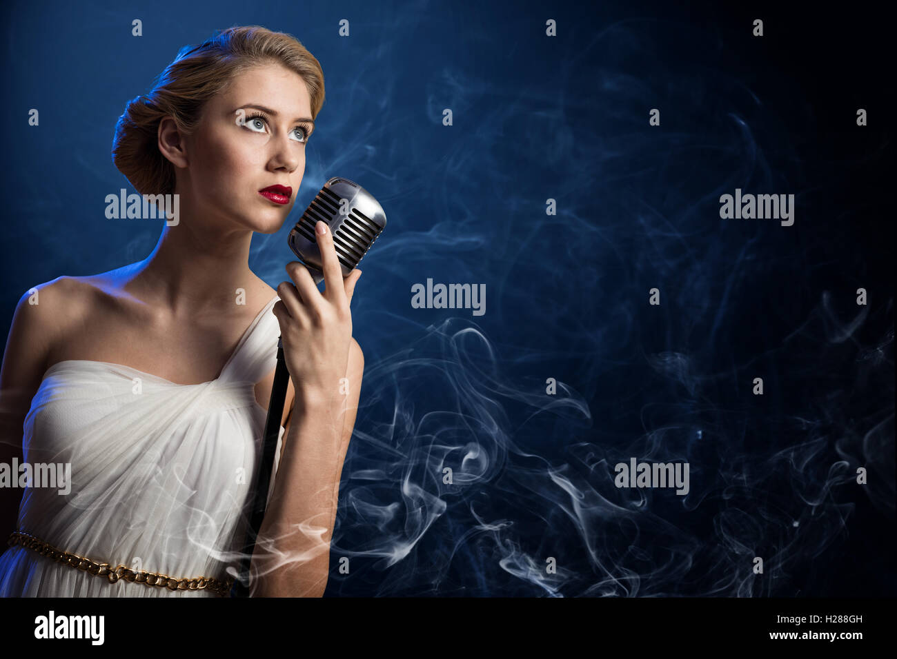 attractive female singer with microphone Stock Photo - Alamy