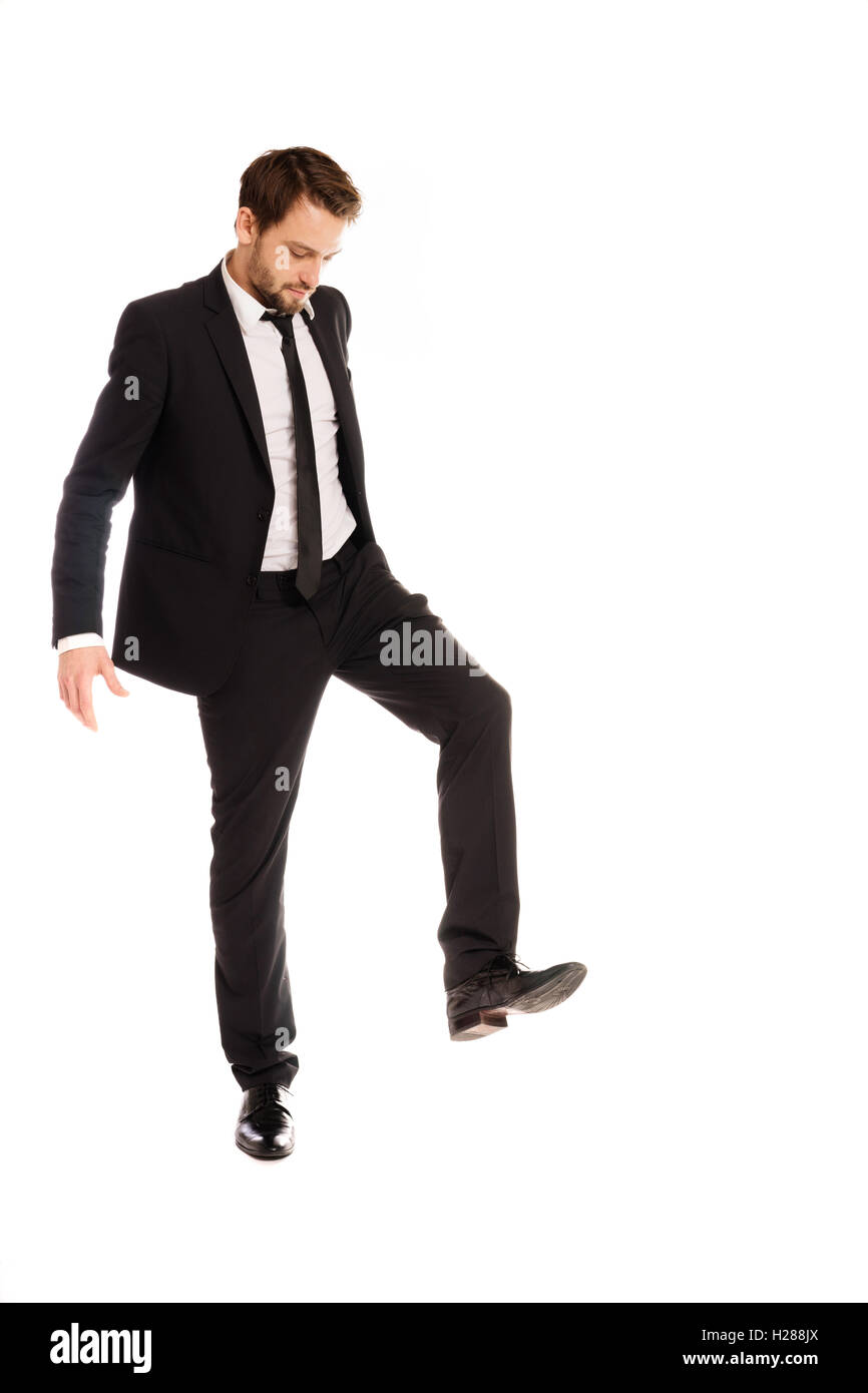 Businessman raising his foot to stamp on something Stock Photo - Alamy