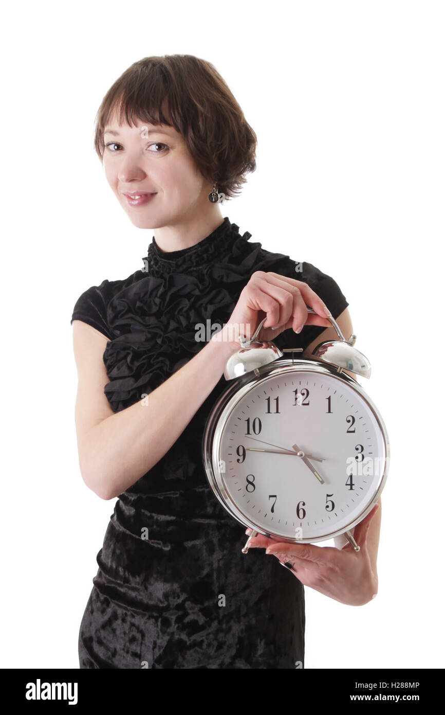 Brunette woman in dress holding clock Stock Photo - Alamy