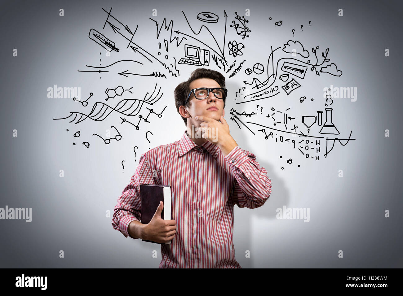 young man scientist with glasses thinking Stock Photo - Alamy