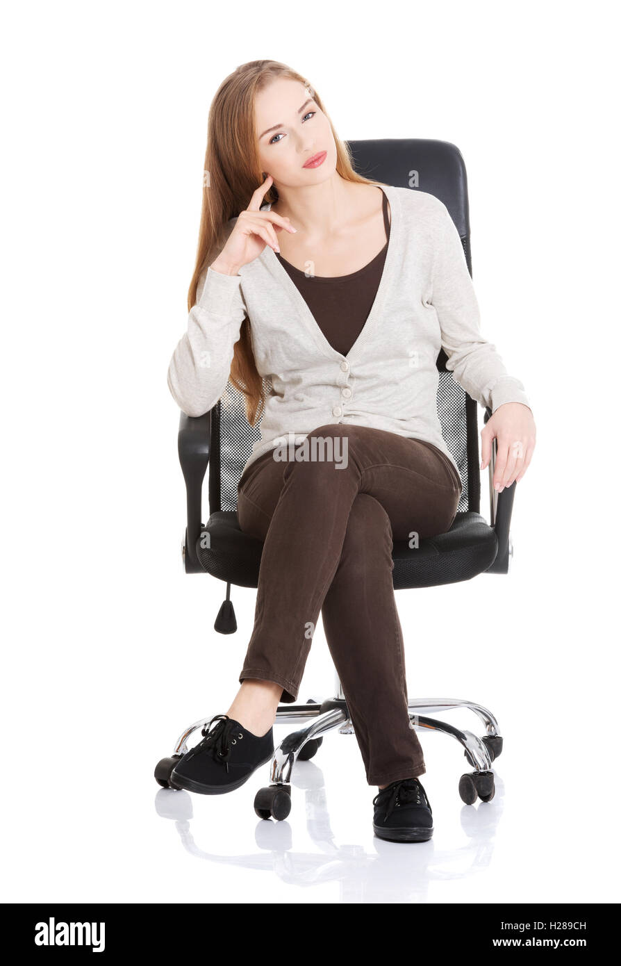 Beautiful casual woman sitting on a chair Stock Photo - Alamy