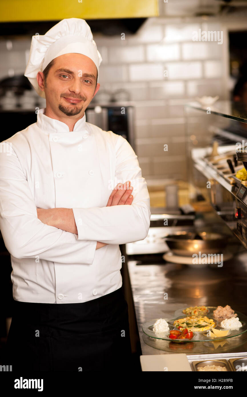 Young male chef posing with confidence Stock Photo - Alamy