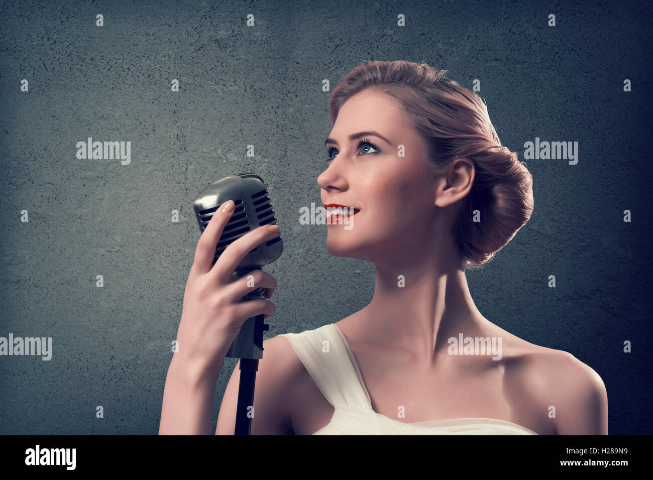 attractive female singer with microphone Stock Photo - Alamy
