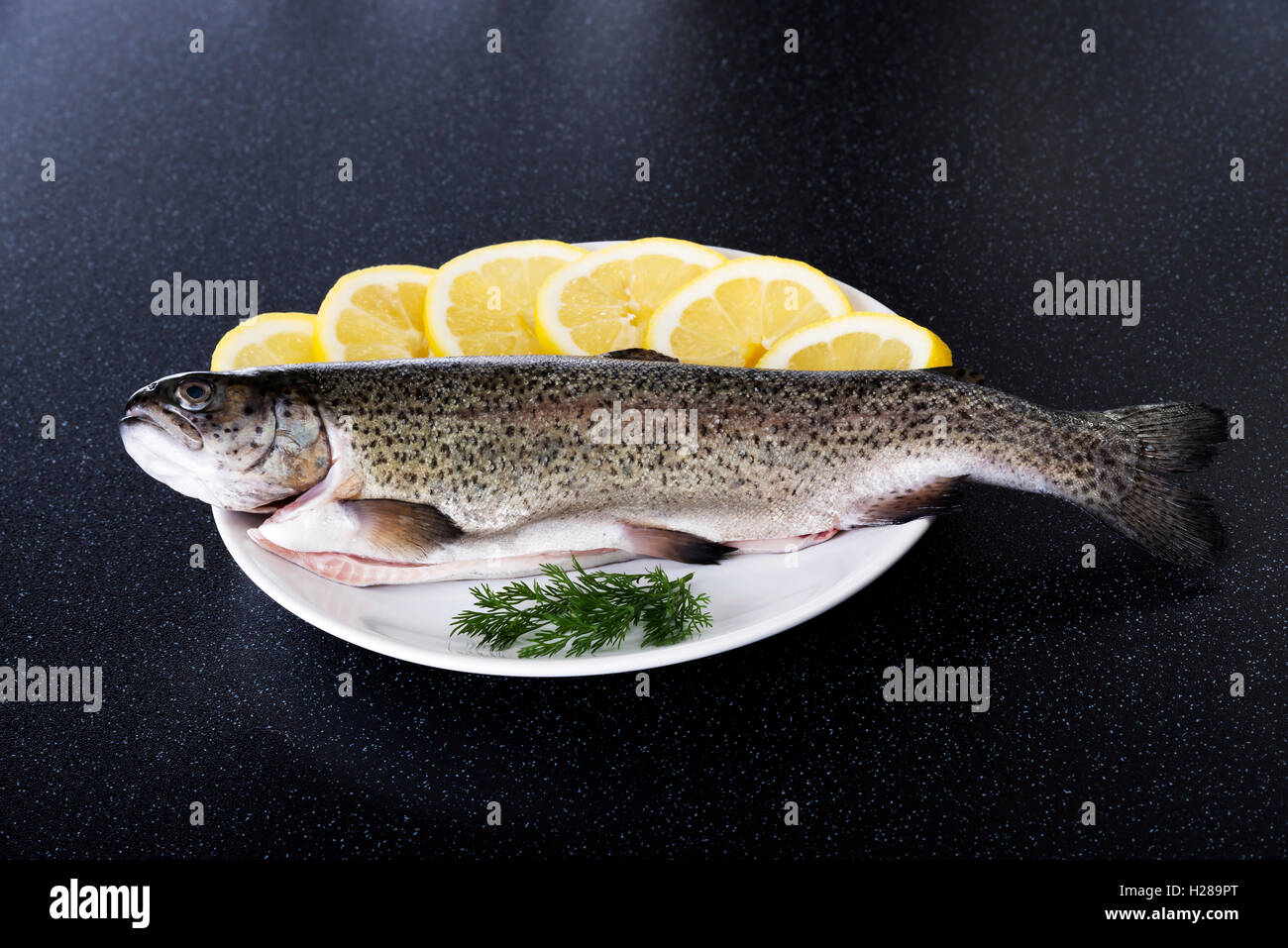 Fresh raw fish lying on a plate Stock Photo - Alamy