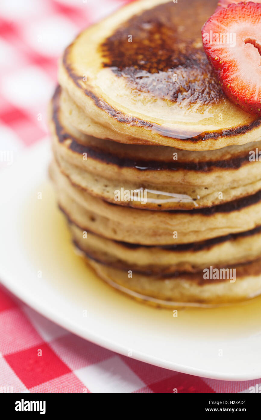 Pancakes, honey and strawberry on checkered fabric Stock Photo - Alamy