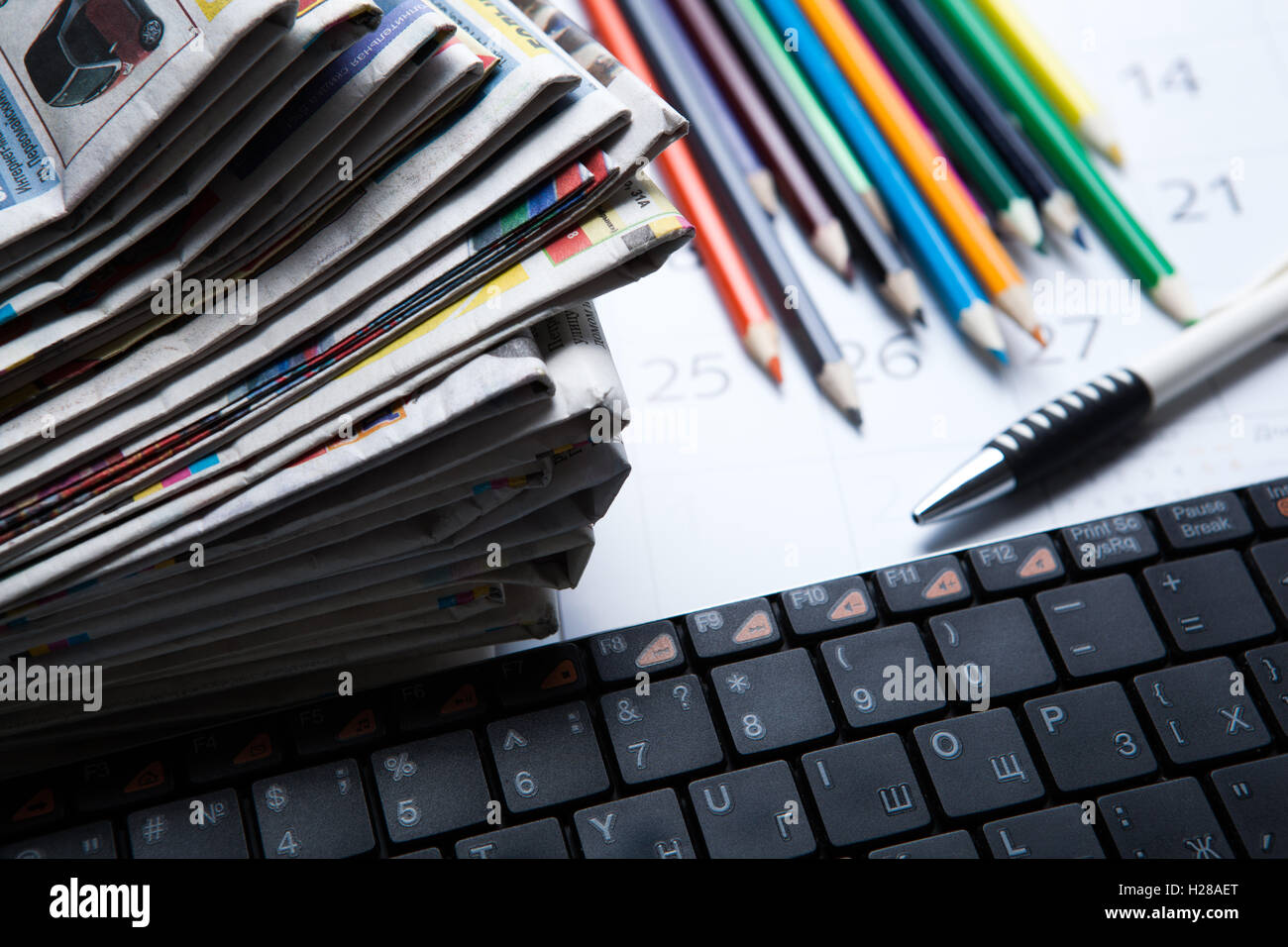 stack of newspapers and keyboard close-up Stock Photo - Alamy