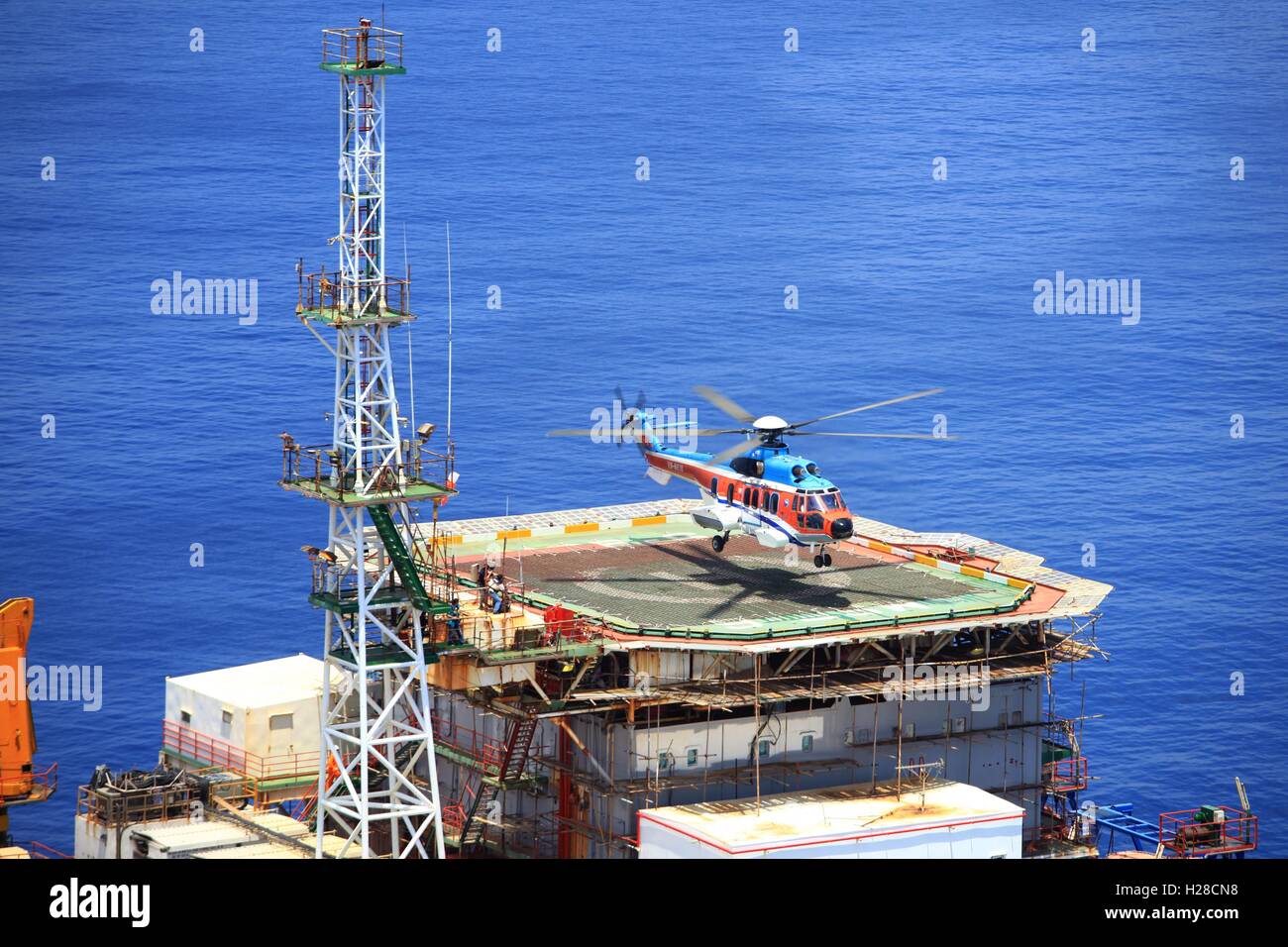 Vung Tau, Vietnam - May 17, 2016: A helicopter is landing on an oil rig ...