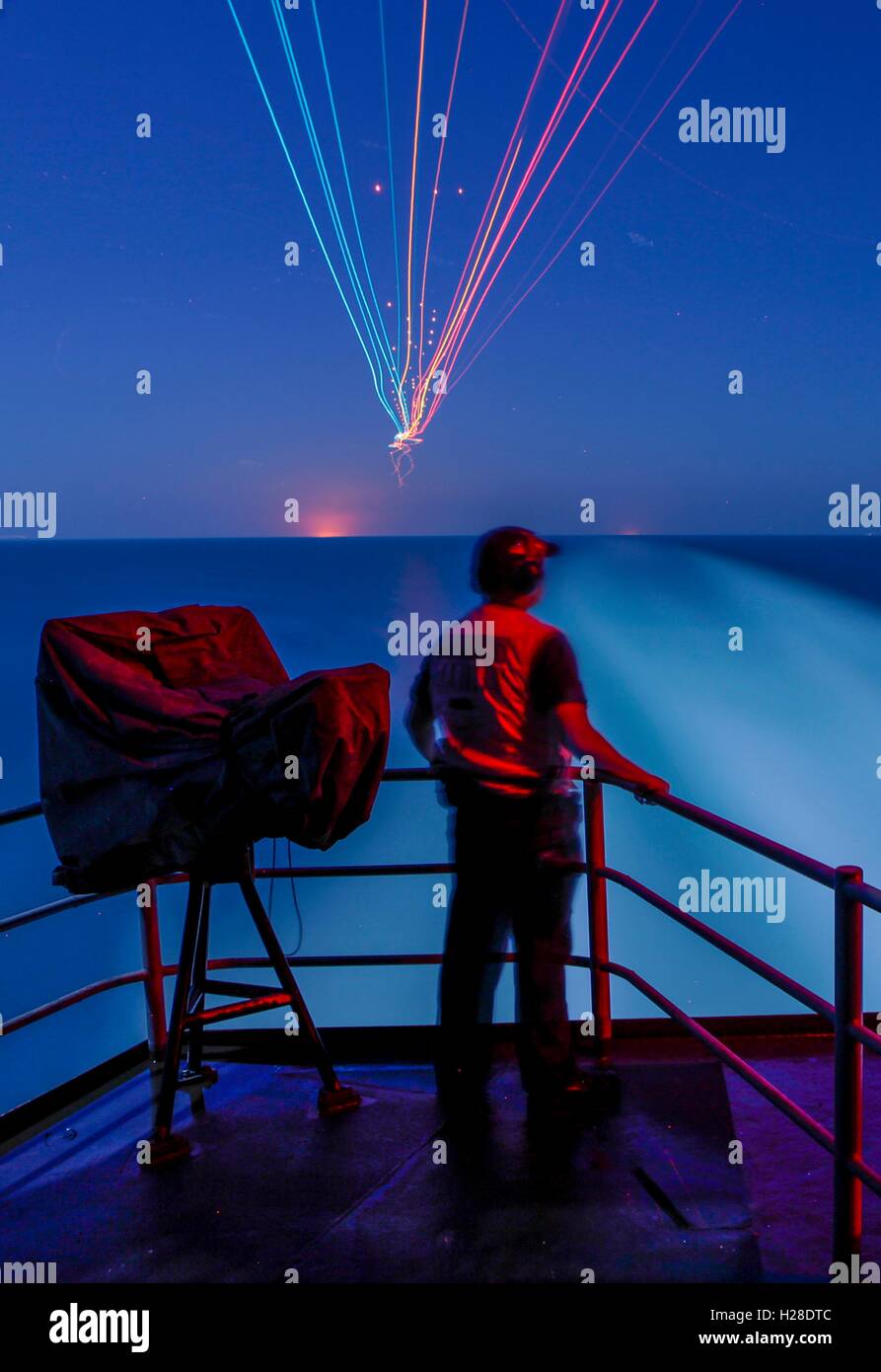 A U.S. Navy sailor stands watch on the fantail of the Nimitz-class ...