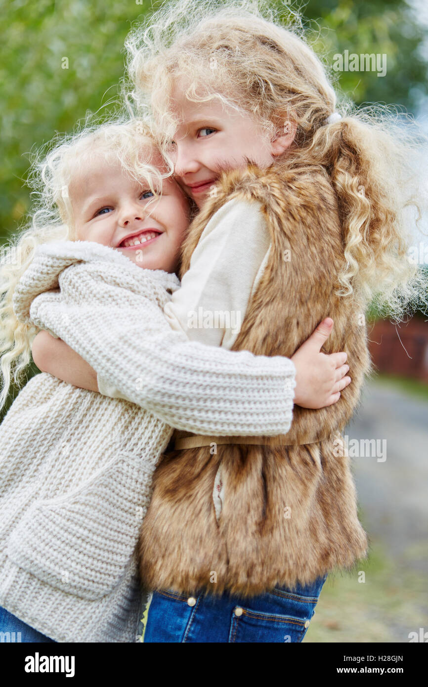 Two girls hugging each other as sign of sibling love and affection ...