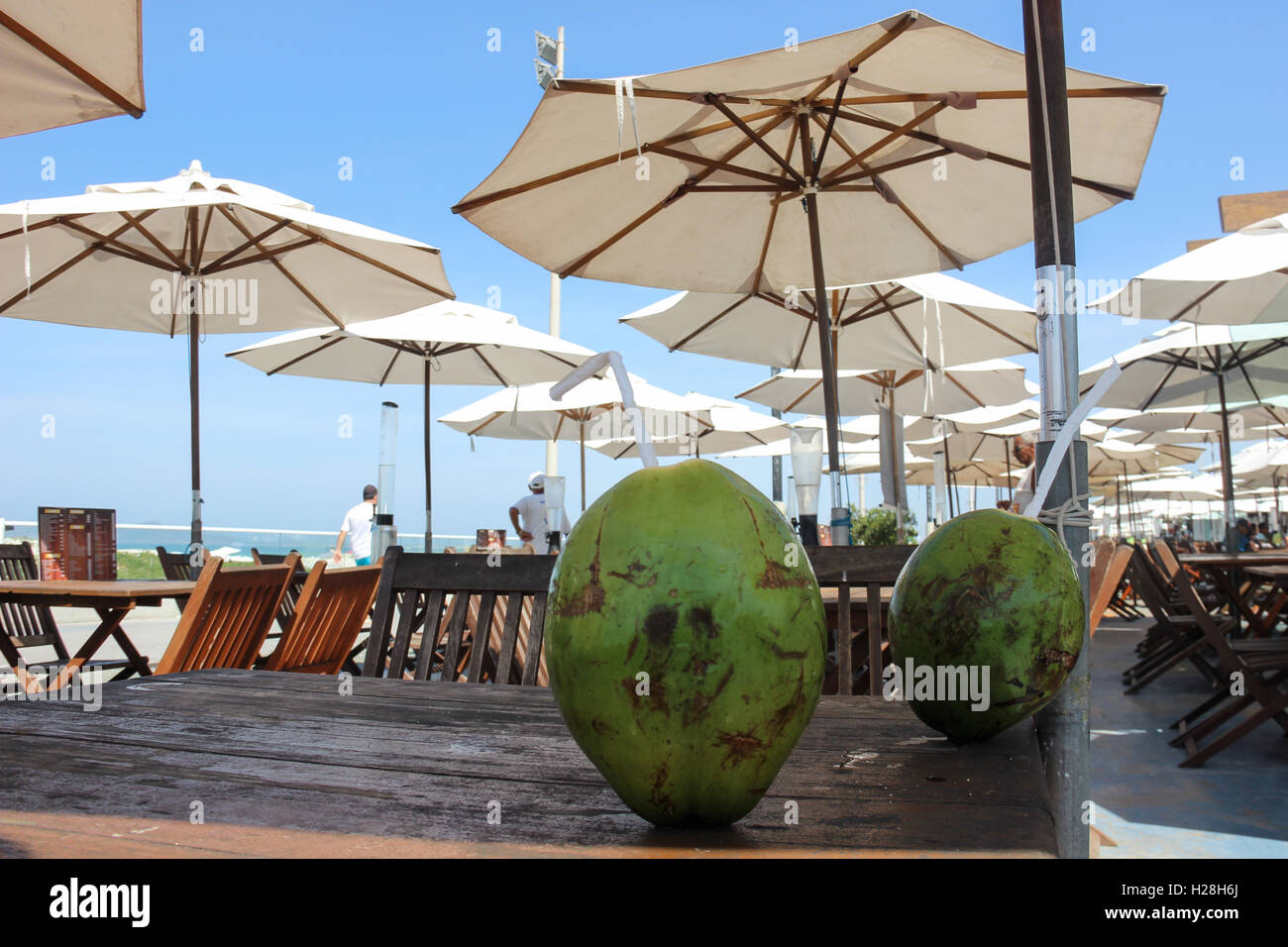 Coconut with straw ready to drink coconut water at beach restaurant ...