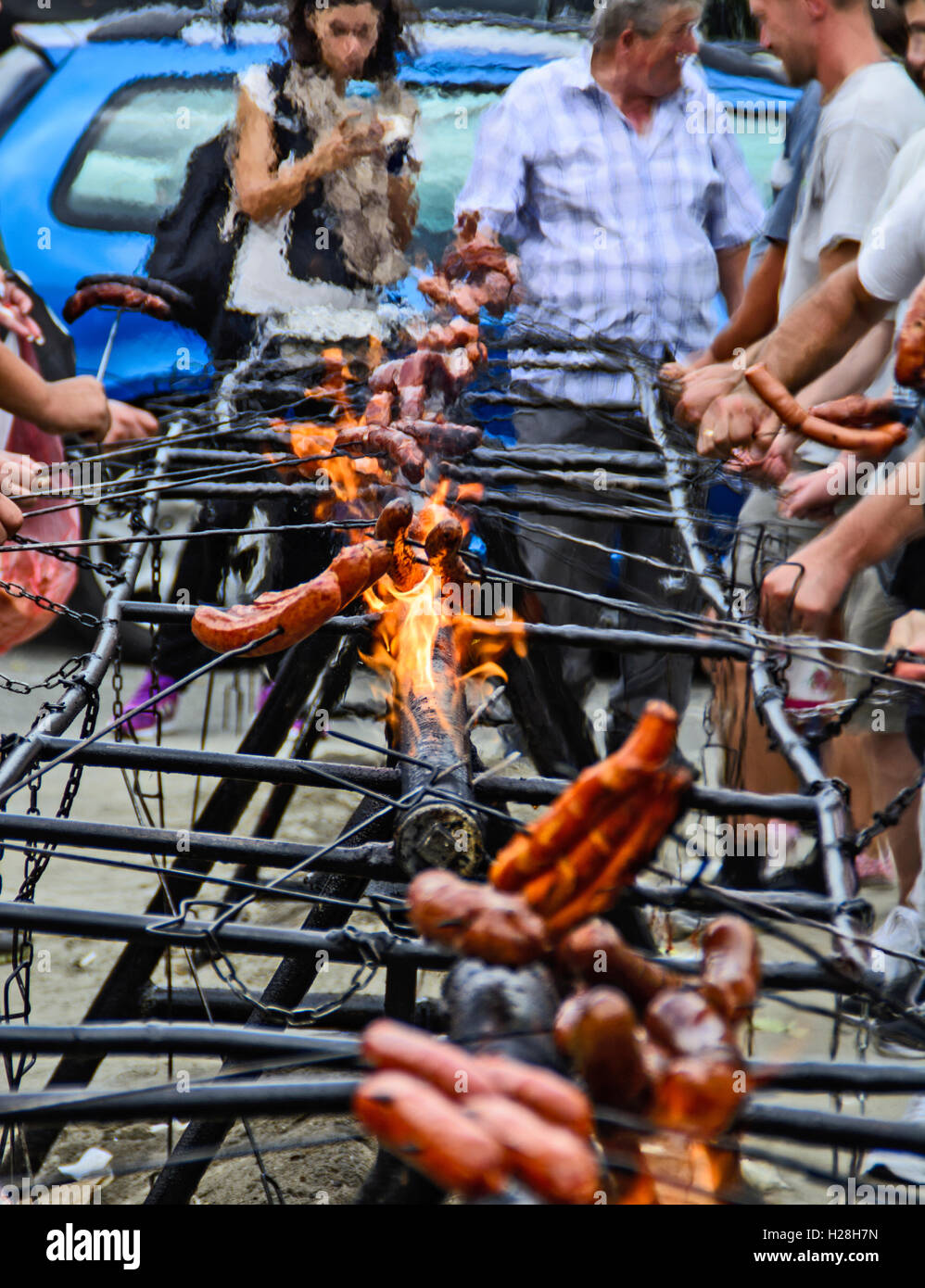 Traditional manifestation street baking sausages on a gas fire Stock ...