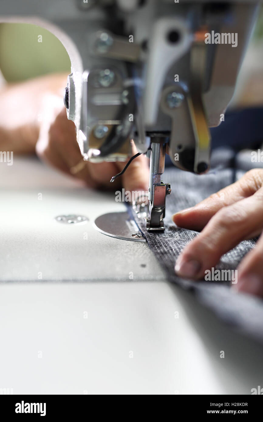 The production plant, sewing clothes by seamstresses on the sewing ...