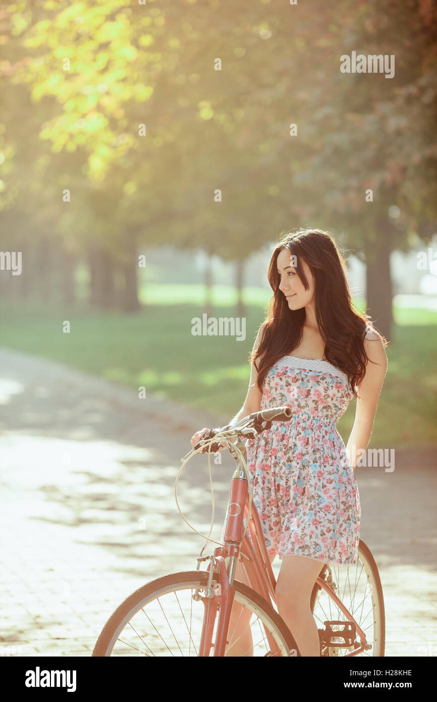 The young girl with bicycle in park Stock Photo - Alamy