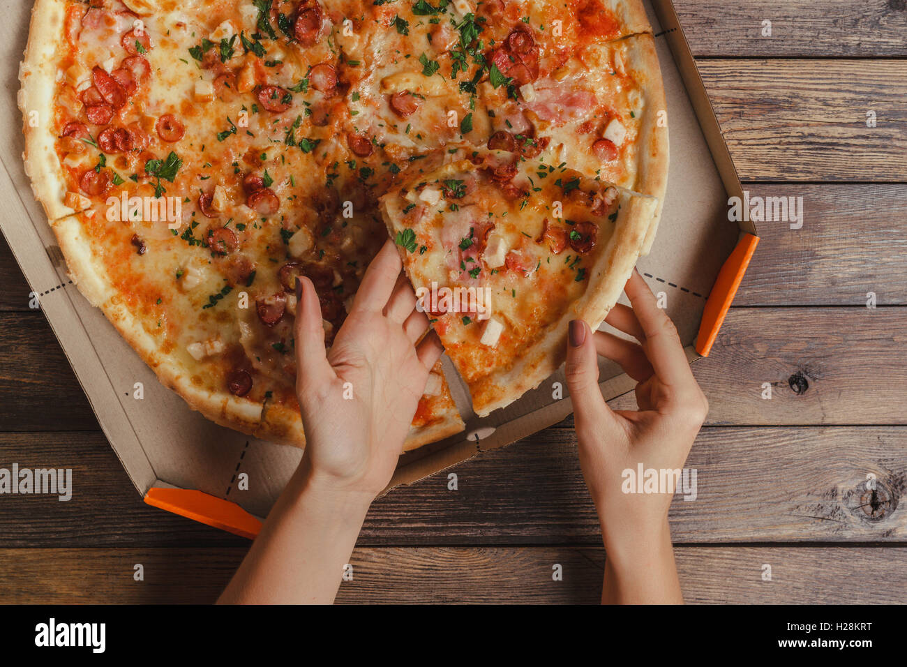 Female Hands Taking Slice Of Pizza Stock Photo - Alamy