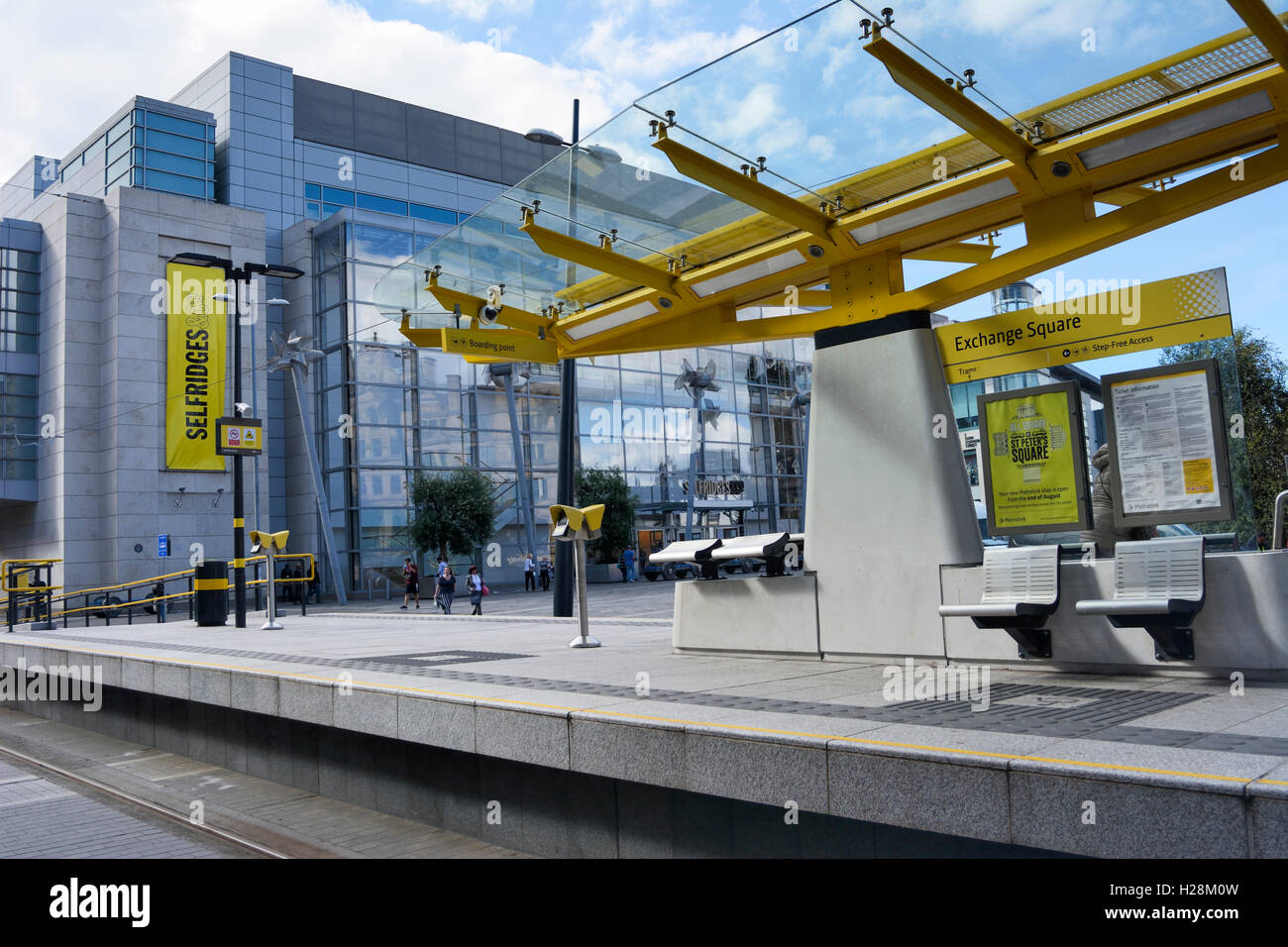 Tram stop in Exchange Square, Manchester City centre with Selfridges in ...