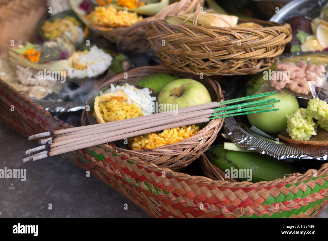 Indonesia, Bali, Batur, Pura Ulun Danu Batur, smoking incense sticks on ...