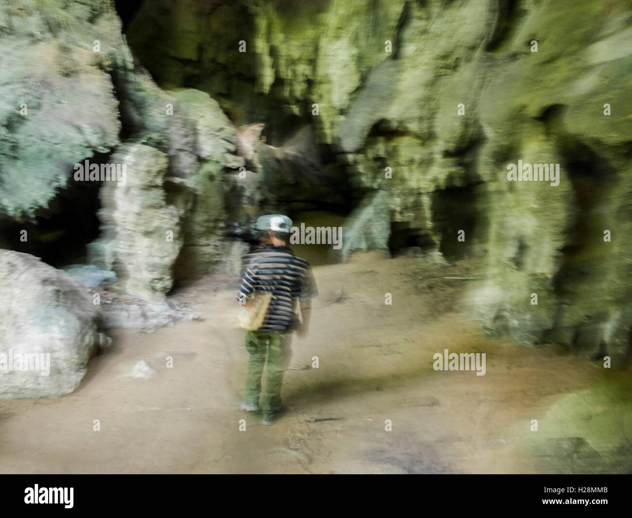 A tour guide walking in a cave Stock Photo - Alamy