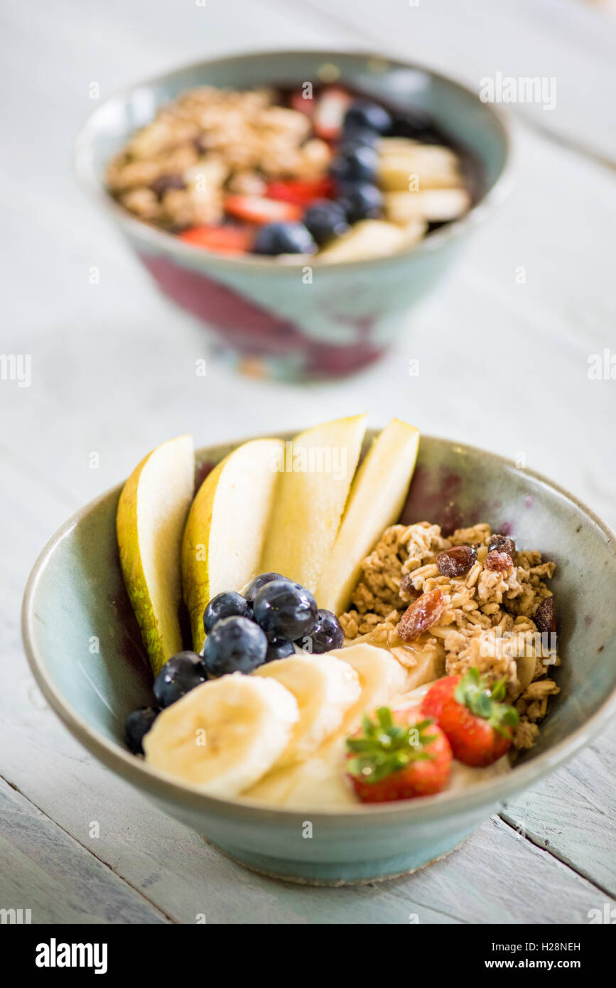 Fruit and muesli breakfast on rustic table Stock Photo - Alamy